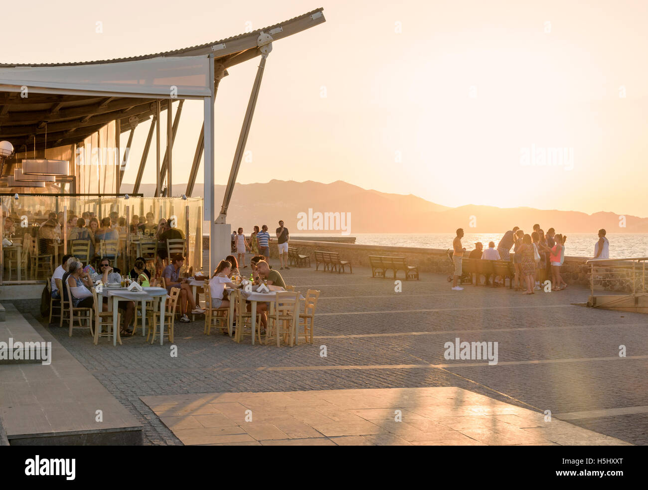 Sunset over the waterfront cafes and restaurants of Heraklion, Crete ...