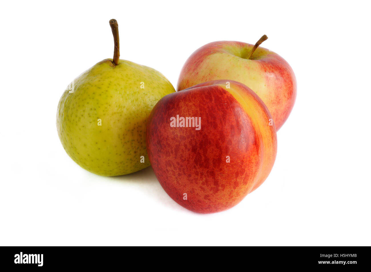 ripe nectarine and pear and apples are located as a triangle on a white ...