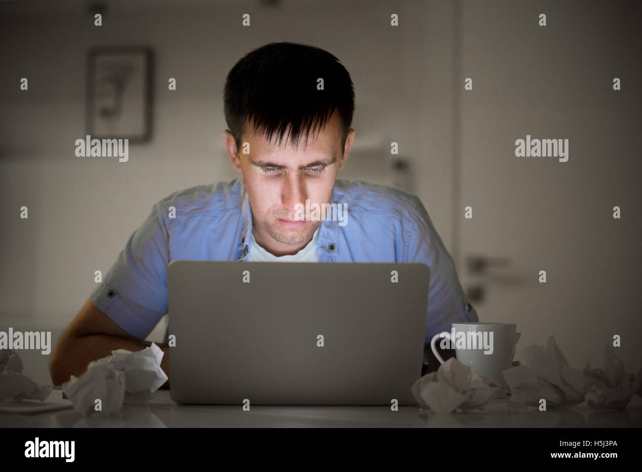 Portrait of a man with a laptop, late at night, screen light Stock ...
