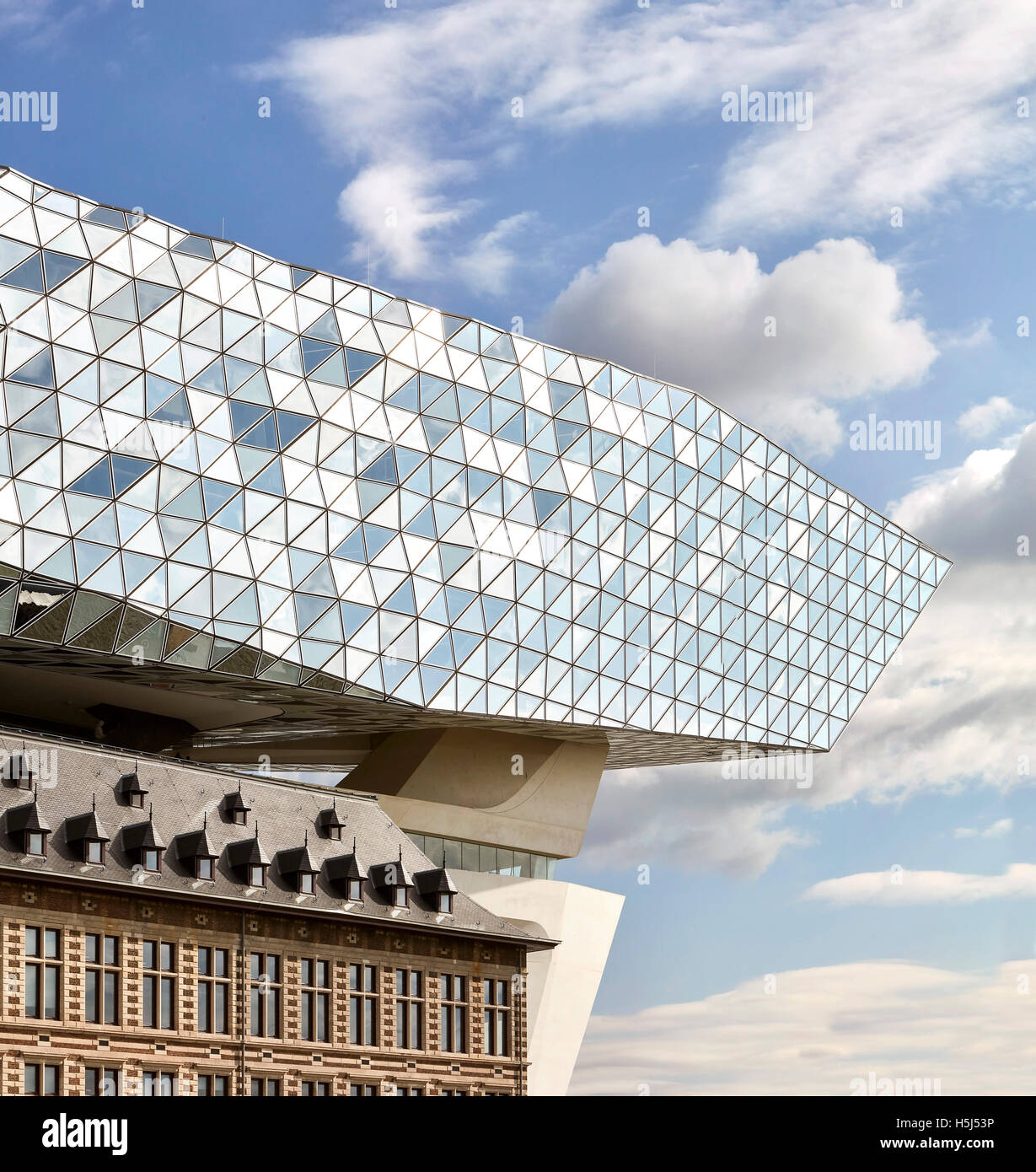 Facade detail of old fire station and floating glazed volume in ...
