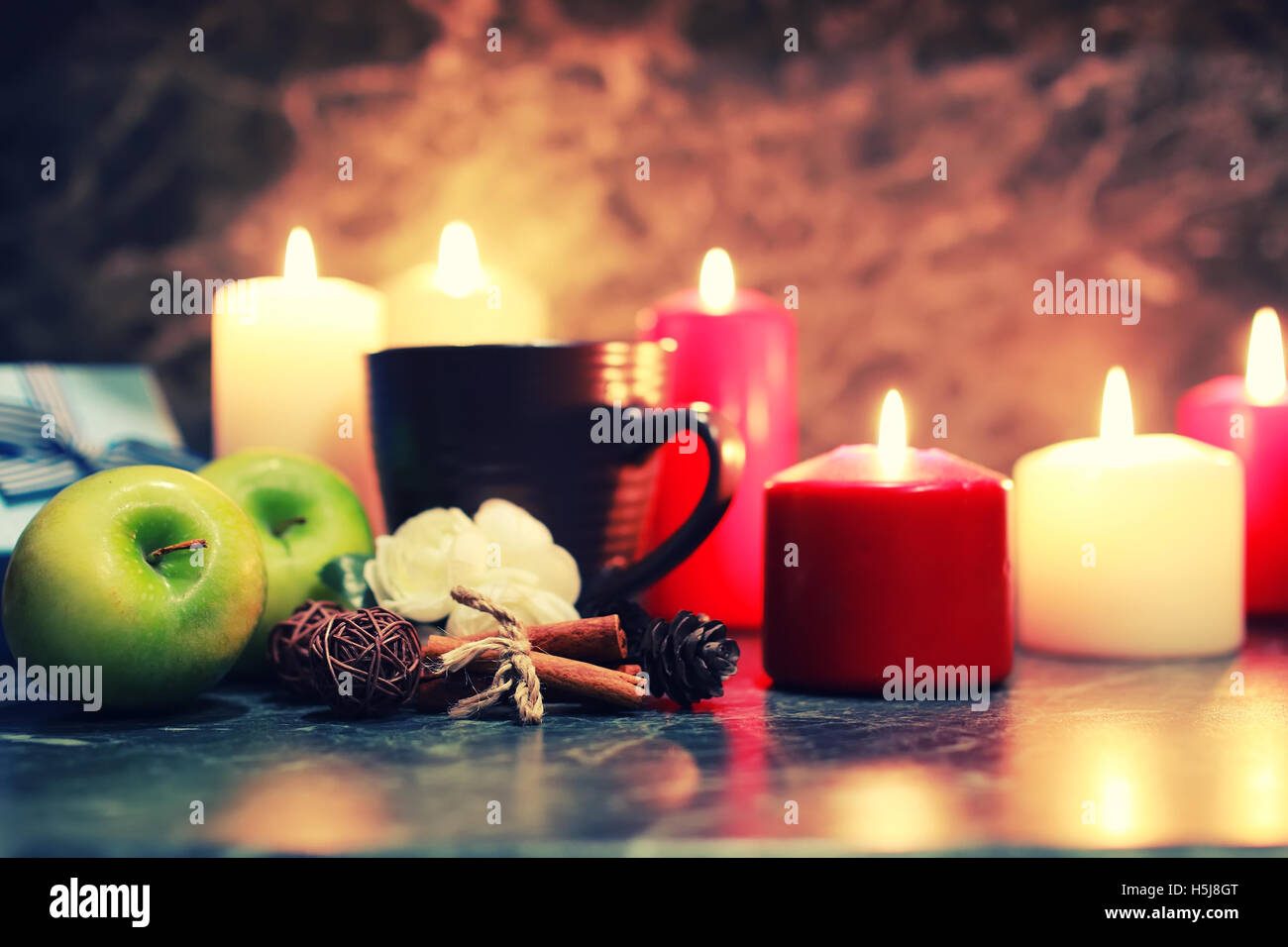 night table with mug and candle Stock Photo - Alamy