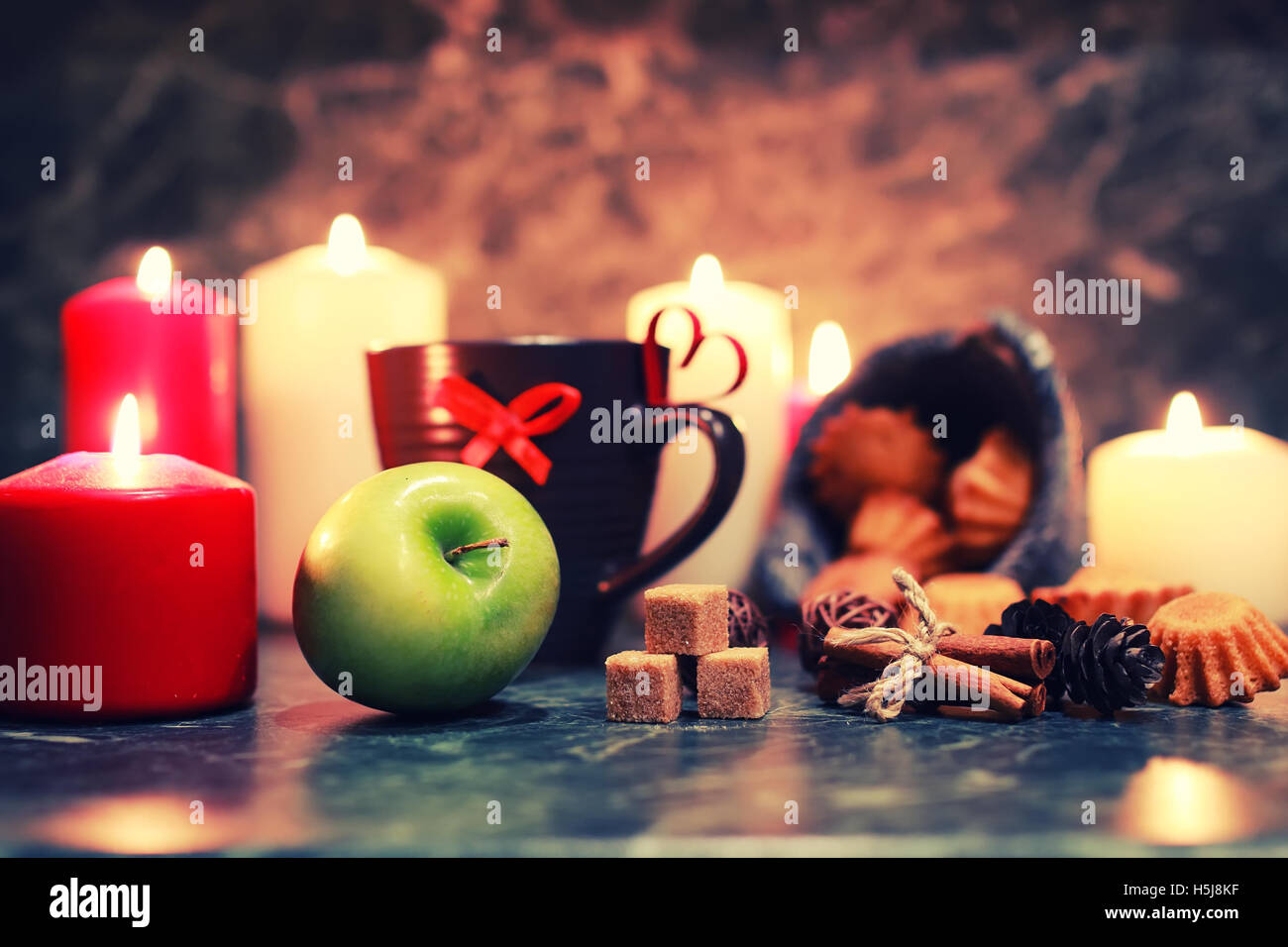 night table with mug and candle Stock Photo - Alamy