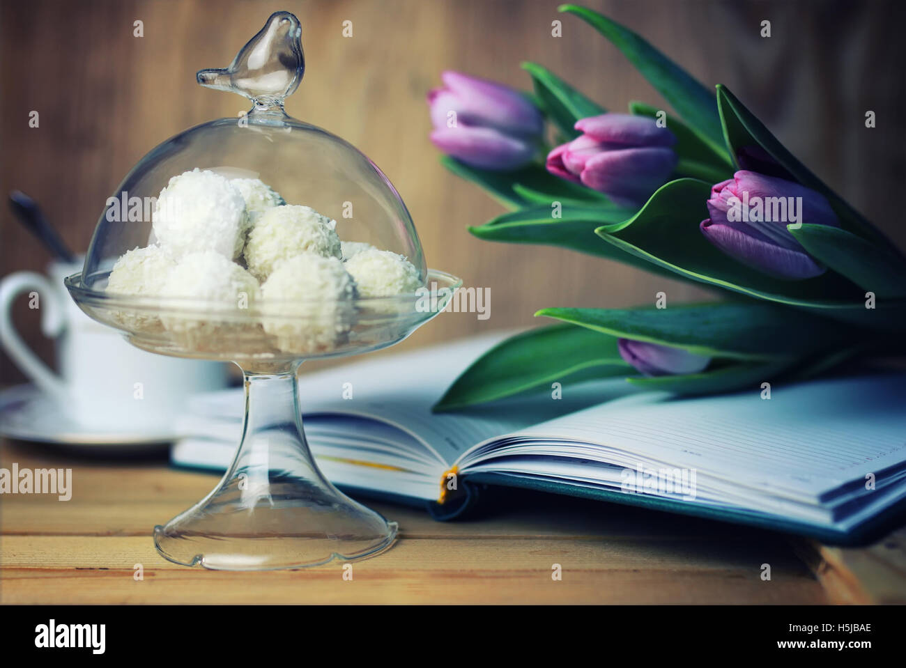 reading book with tea flower and sweet Stock Photo - Alamy