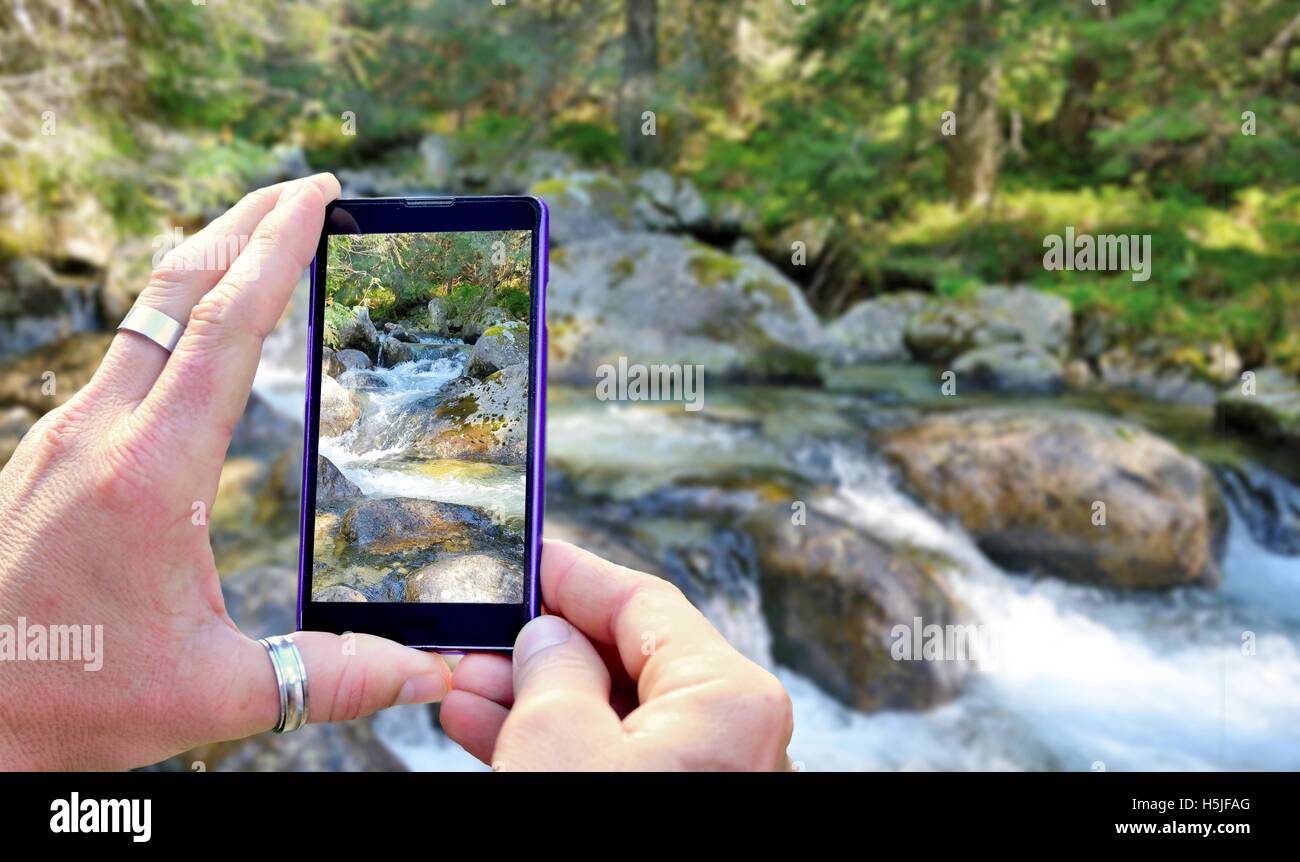 View over the mobile phone display during taking a picture of landscape ...