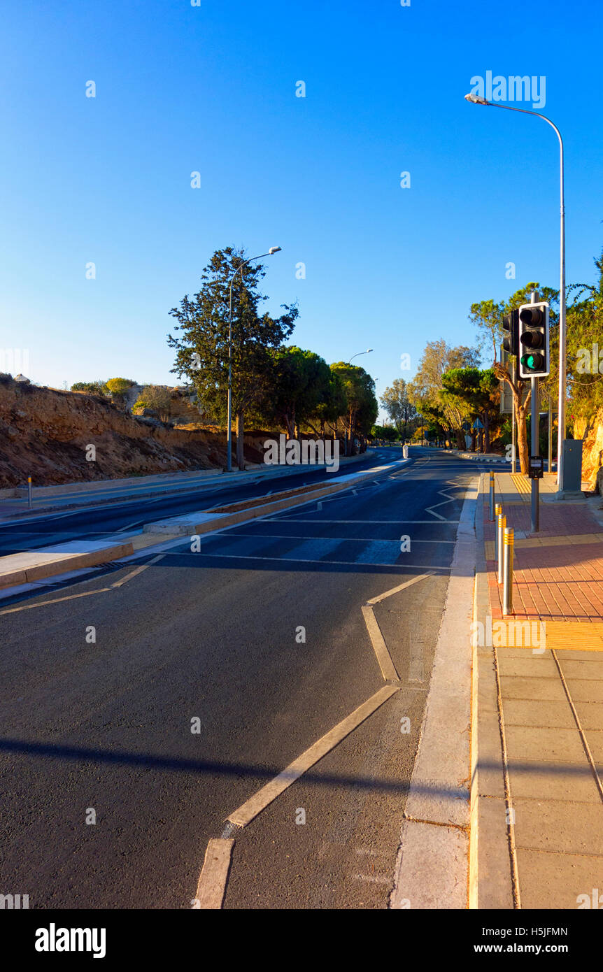 Empty road with green traffic light. Urban scene. Sunny day Stock Photo ...