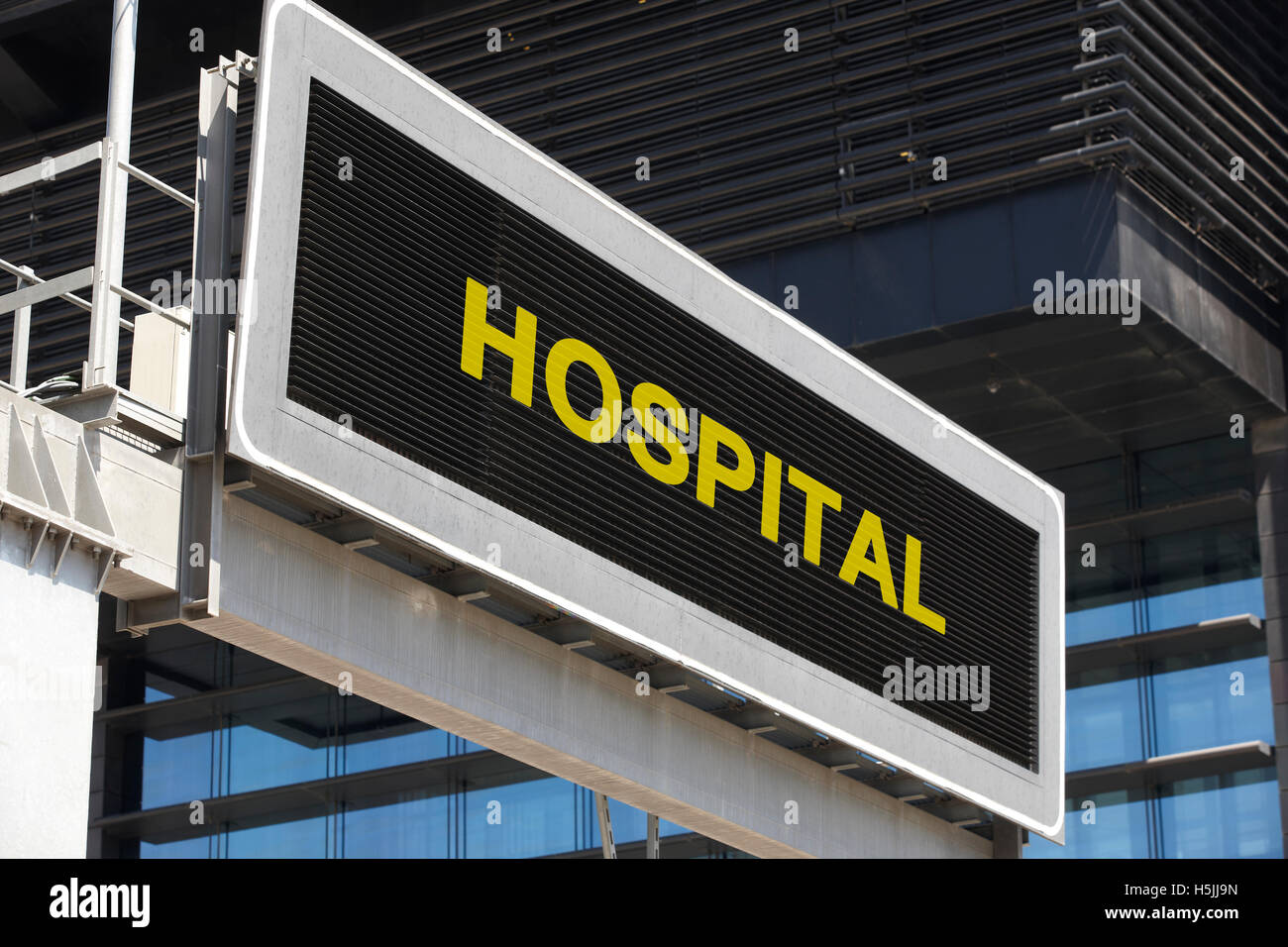 Hospital signpost in the city with building facade background ...