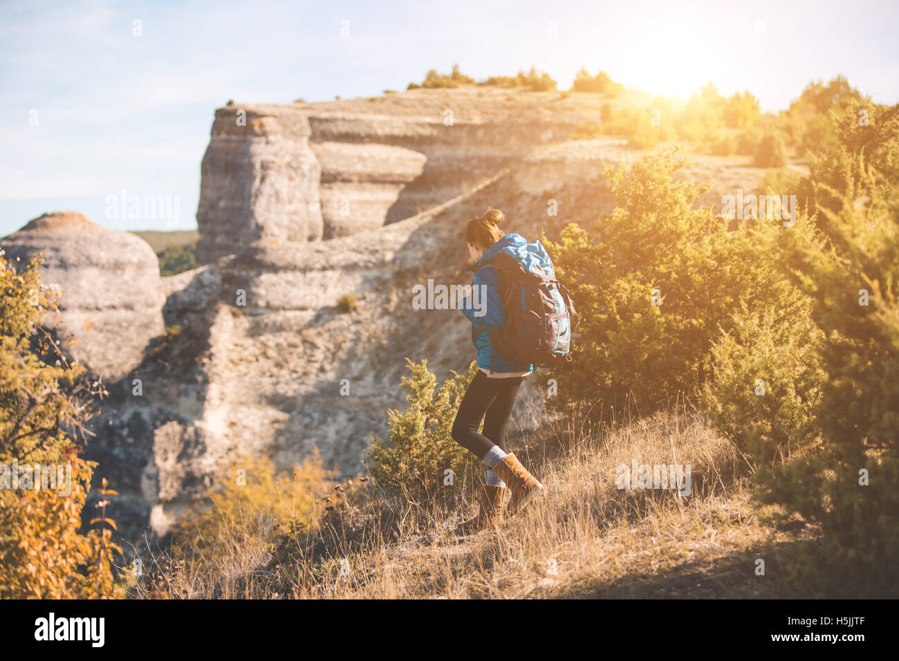 Young girl with backpack enjoying sunset on mountain Stock Photo - Alamy