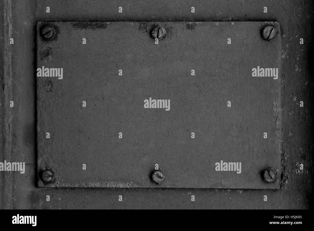 black steel plate with screws or abstract metal background Stock Photo ...
