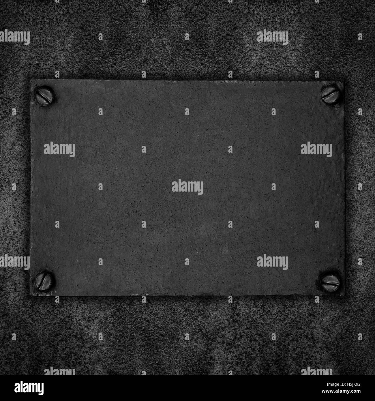 black steel plate with screws on abstract rough background Stock Photo ...