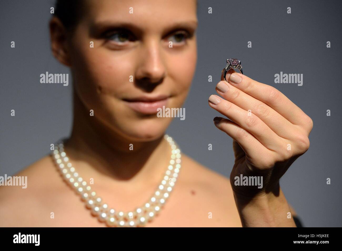 A Christie's employee models the Fancy Vivid Pink pear-shaped diamond ...