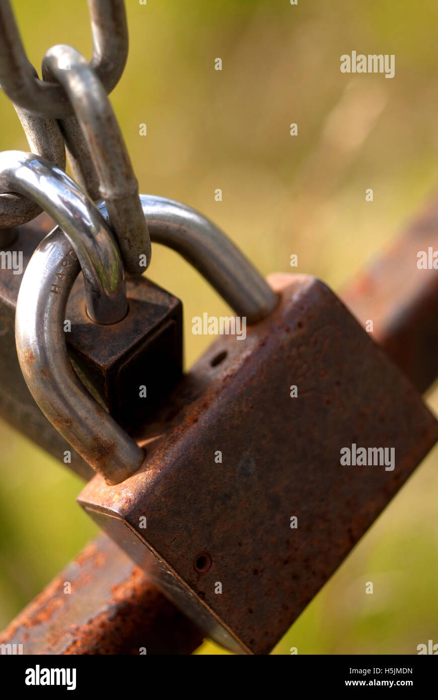 Double locked rusty padlocks and chain Stock Photo - Alamy