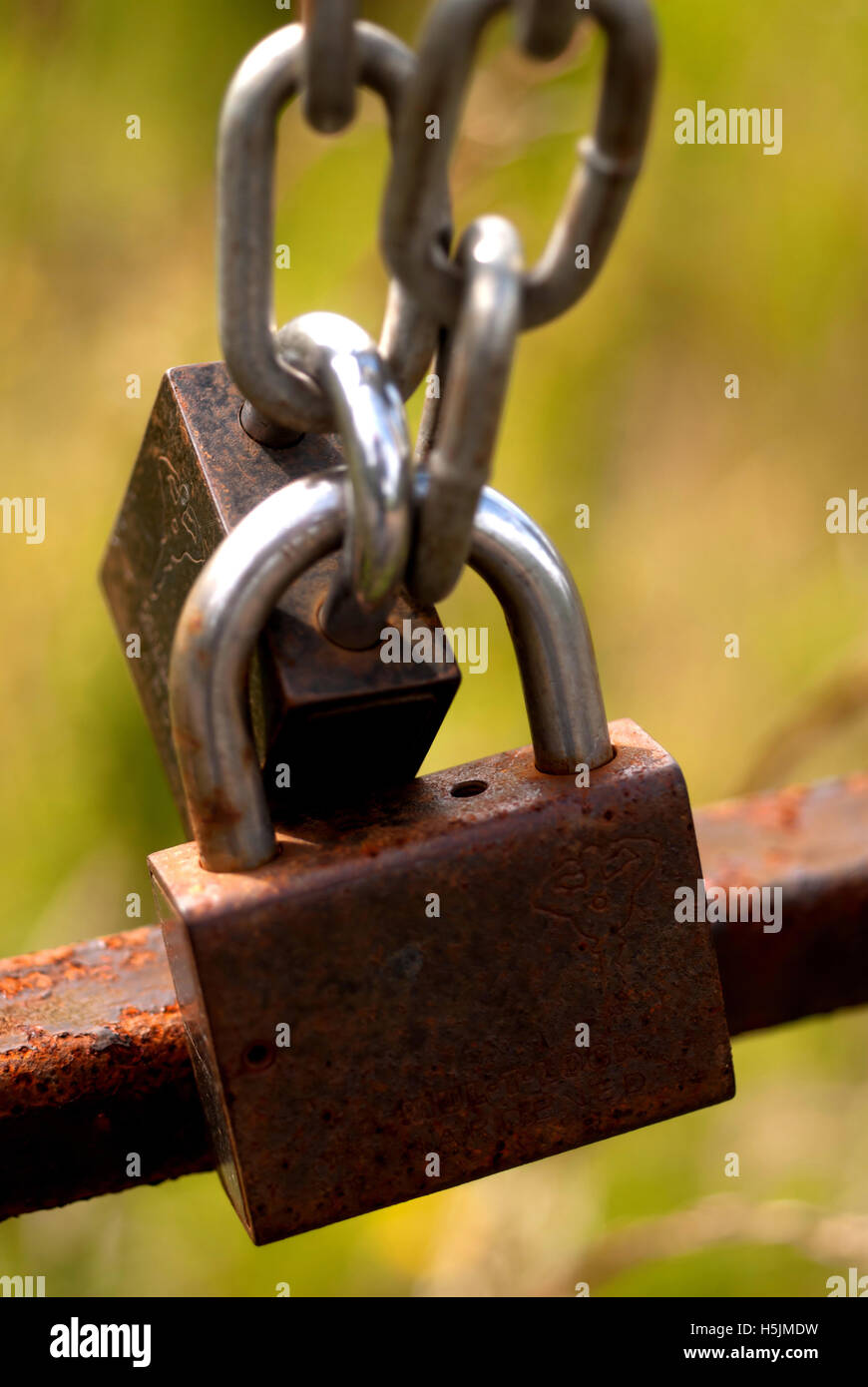 Double locked rusty padlocks and chain Stock Photo - Alamy