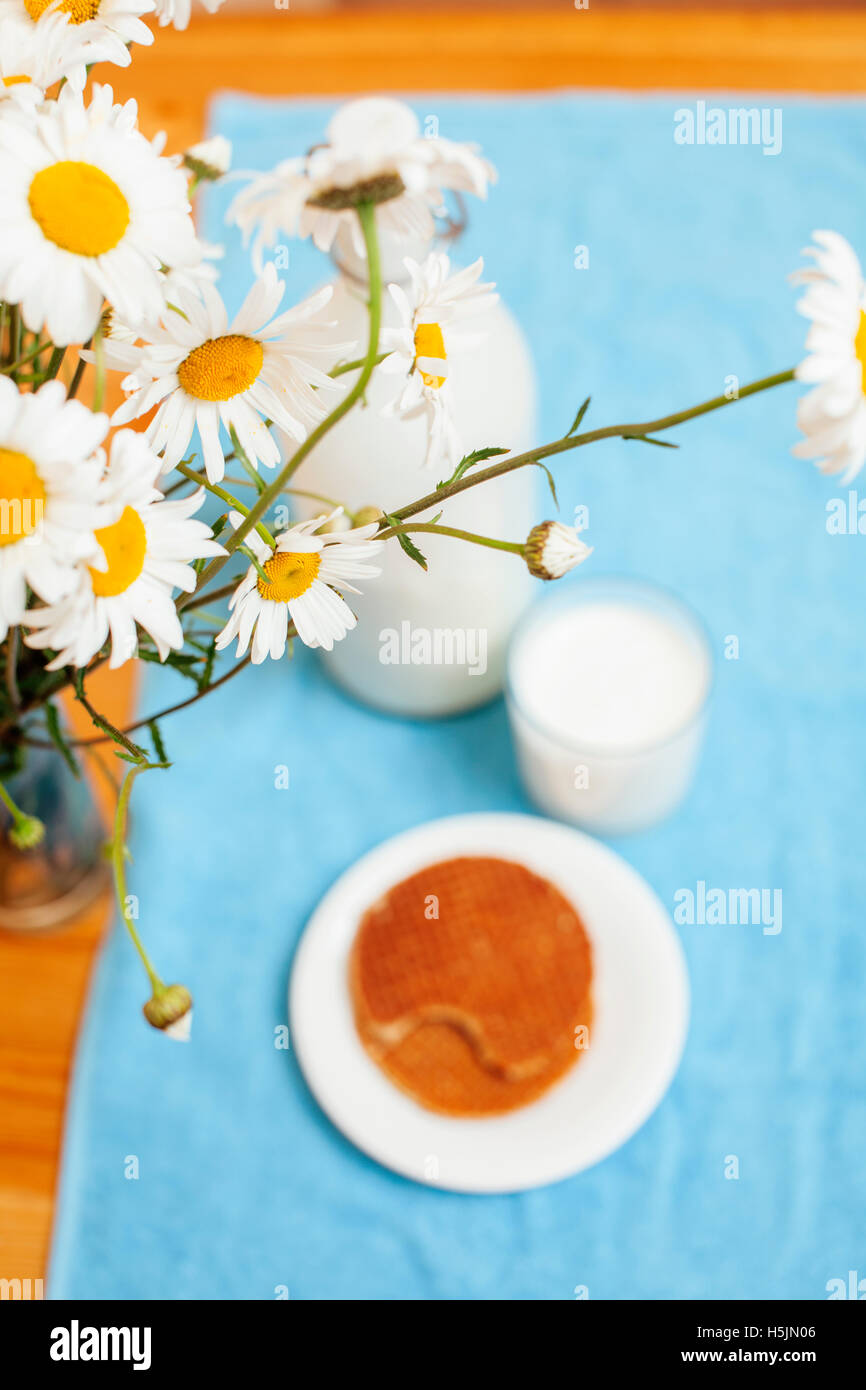Simply stylish wooden kitchen with bottle of milk and glass on table ...