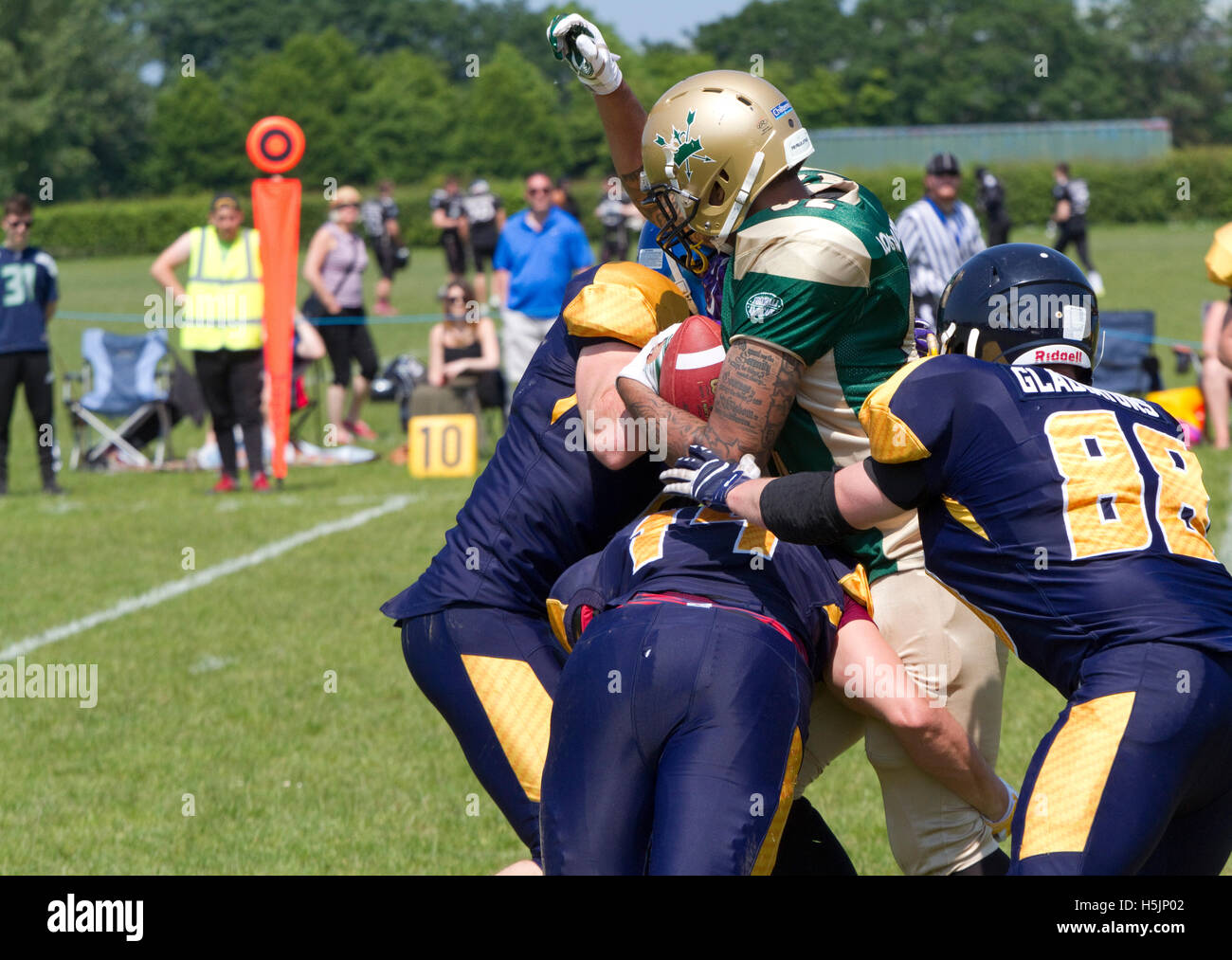 American footballer is gang tackled Stock Photo - Alamy