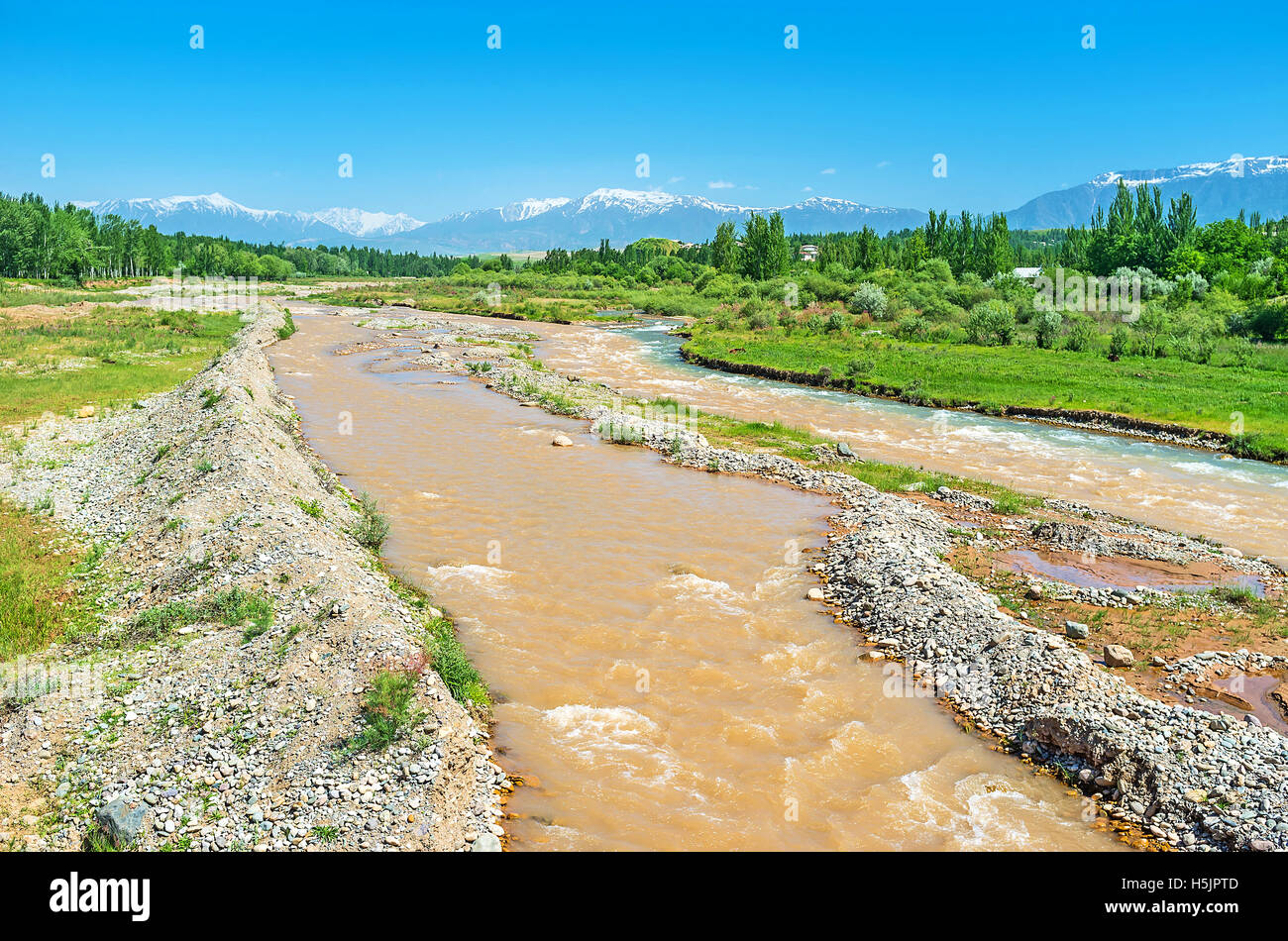 The Yakabag Darya River flows among the meadows and forests with the ...