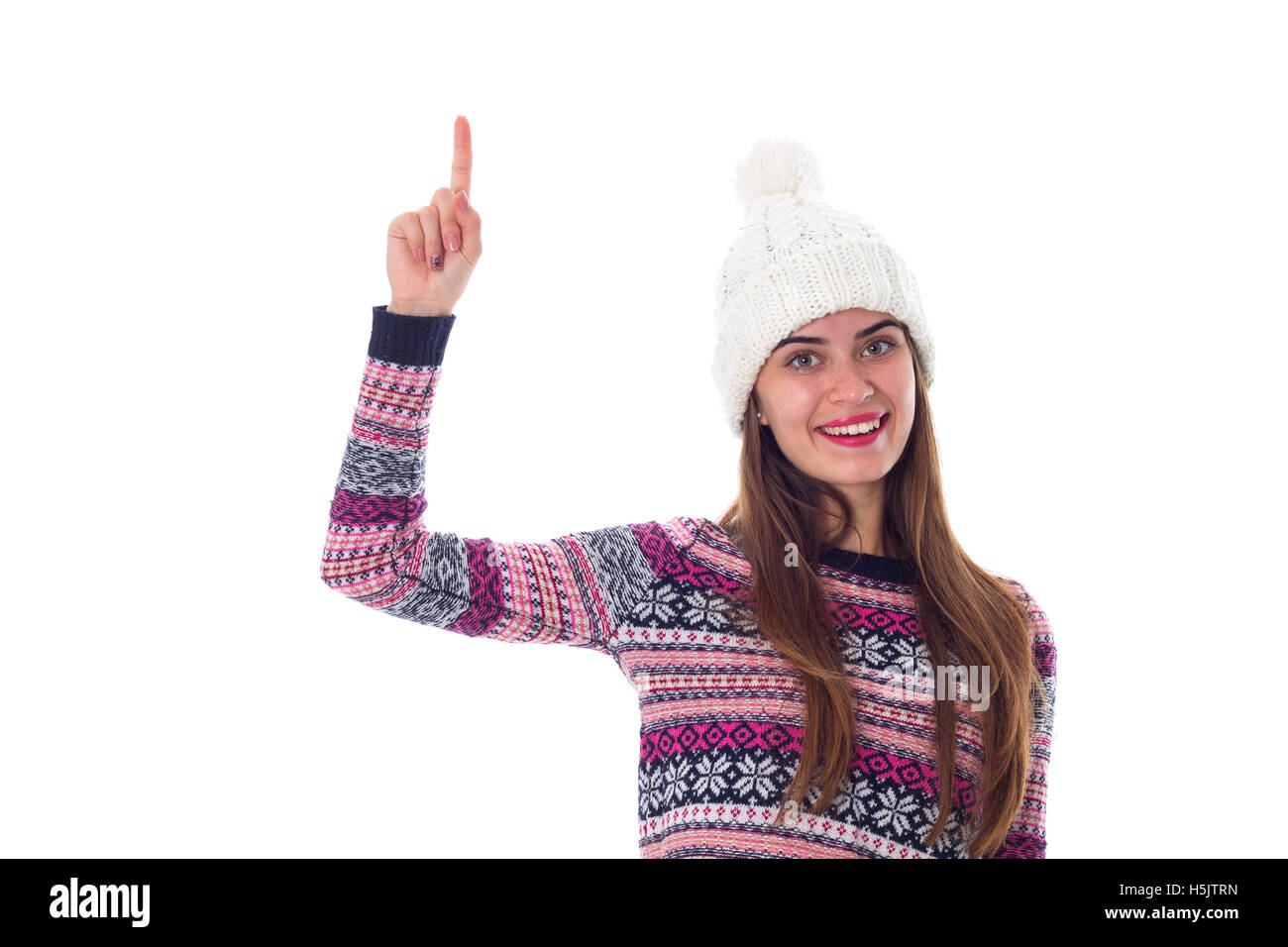 Woman in sweater and white hat pointing up Stock Photo - Alamy