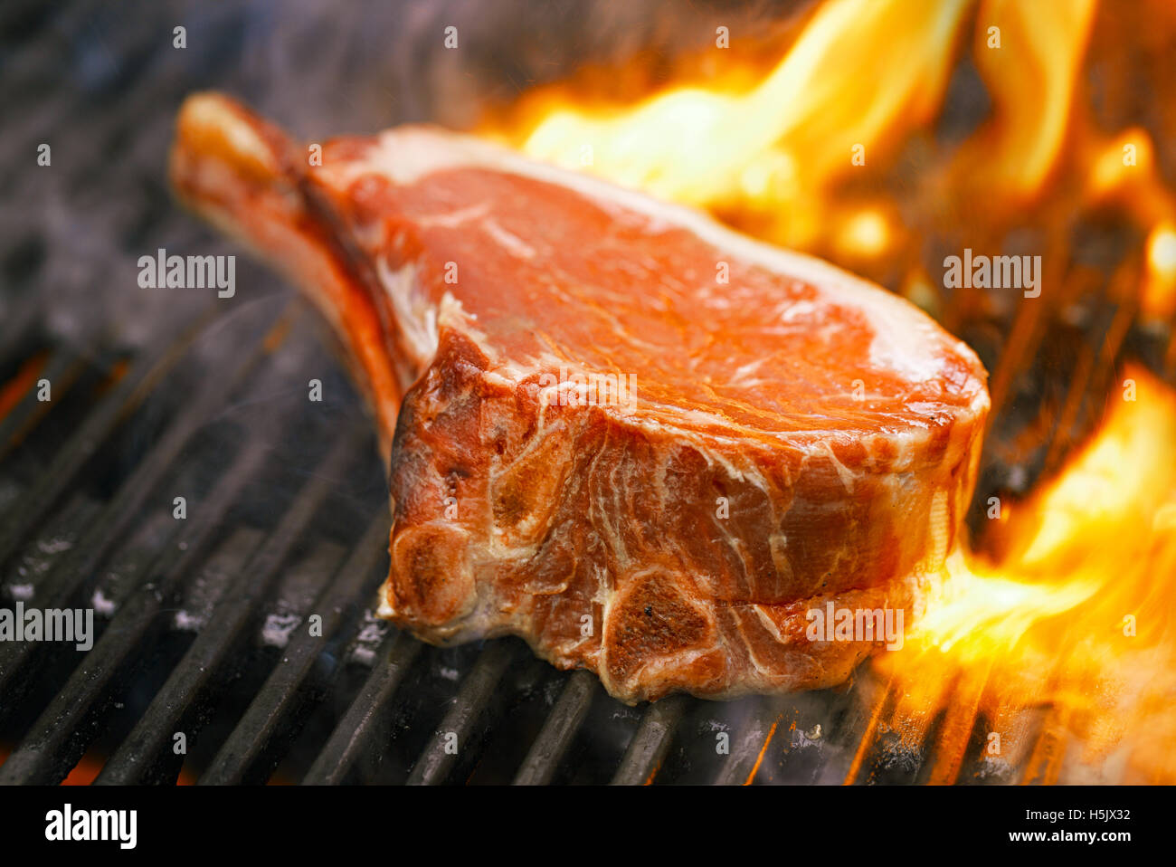 food meat - beef steak on bbq barbecue grill with flame. Shallow dof ...