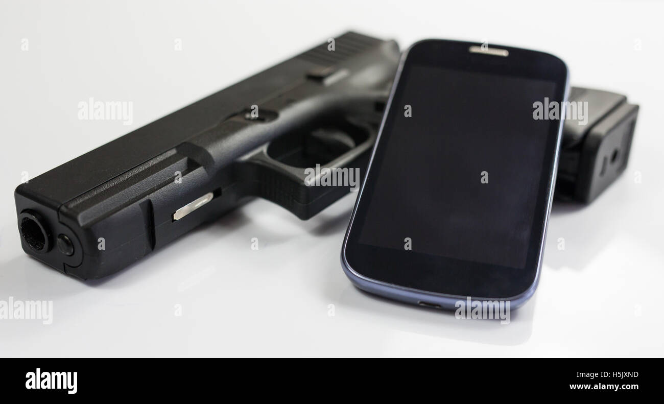 A gun and a modern smart phone Stock Photo - Alamy