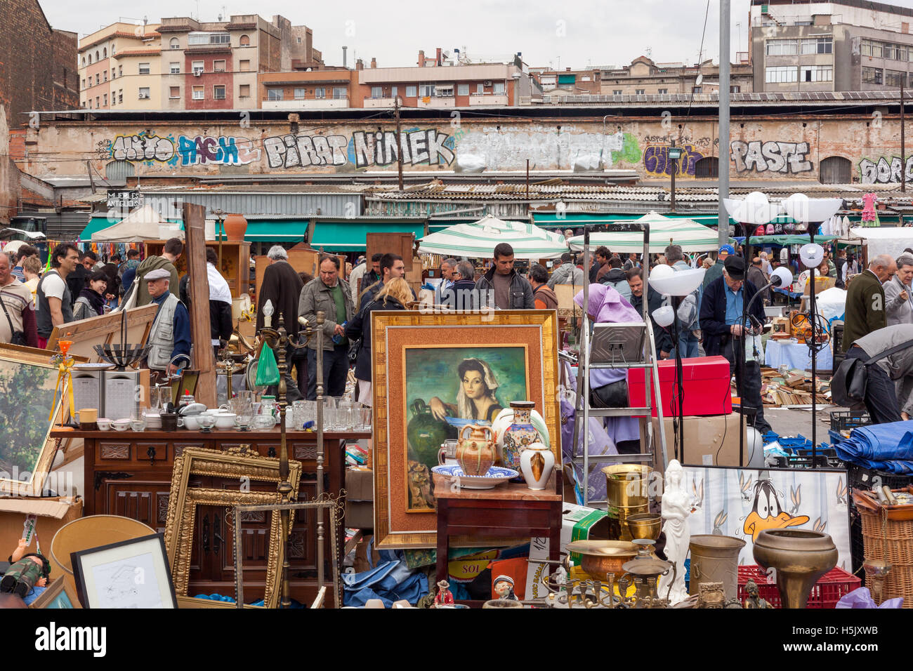 a picture in a flea market with a lady in a painting in the center ...