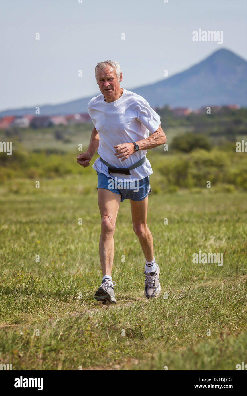Senior man running on road hi-res stock photography and images - Alamy
