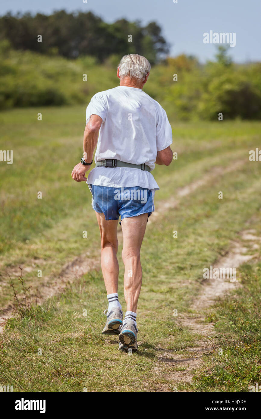 Senior runner running on the field Stock Photo - Alamy