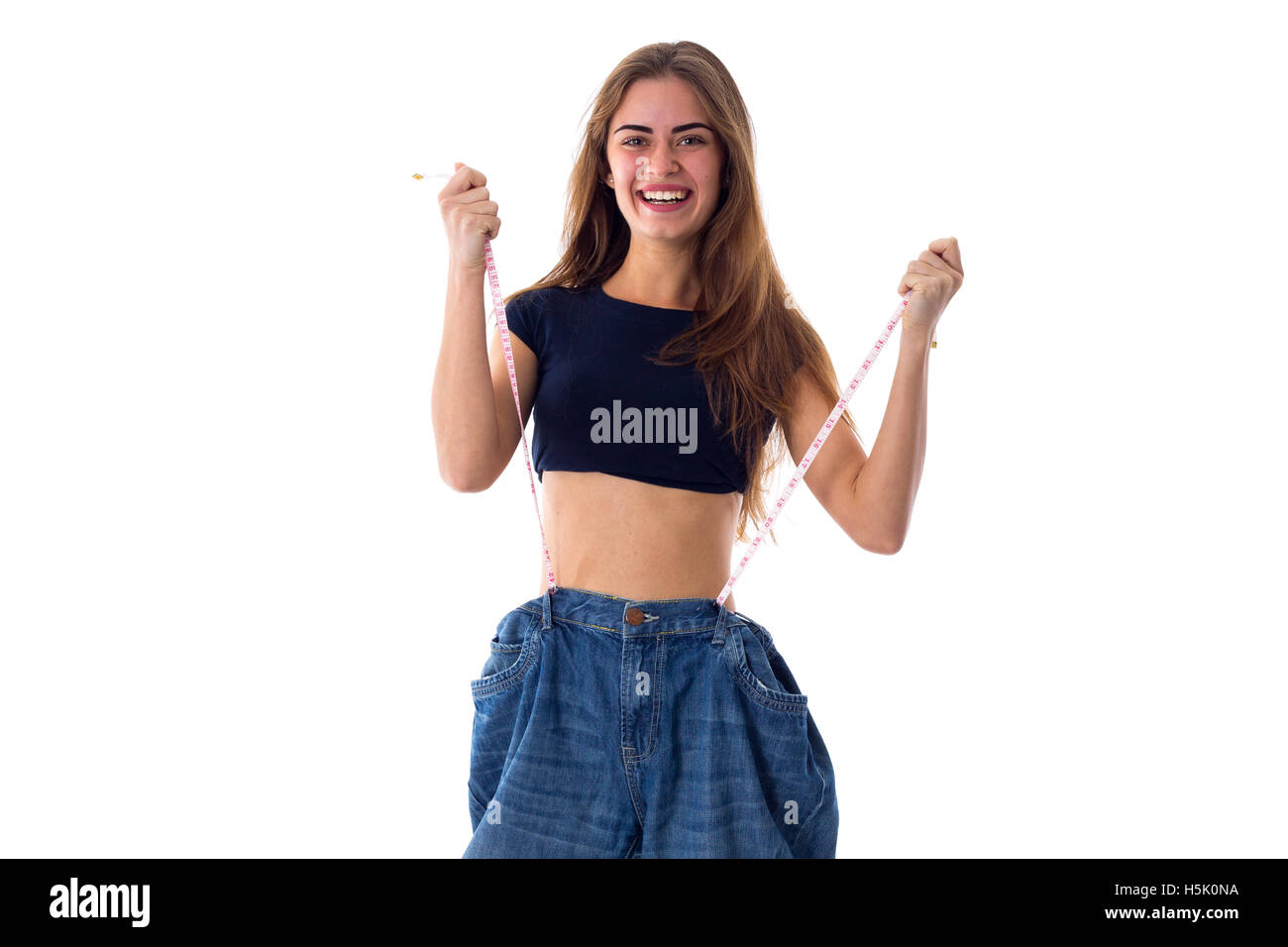 Woman wearing jeans of much bigger size Stock Photo - Alamy