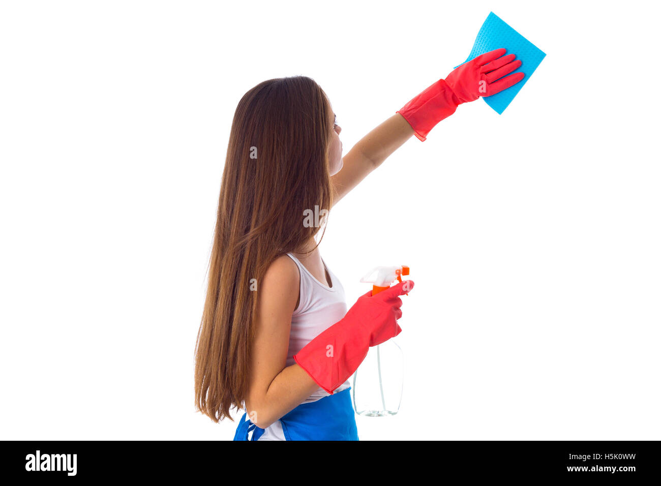 Woman using duster and detergent Stock Photo - Alamy