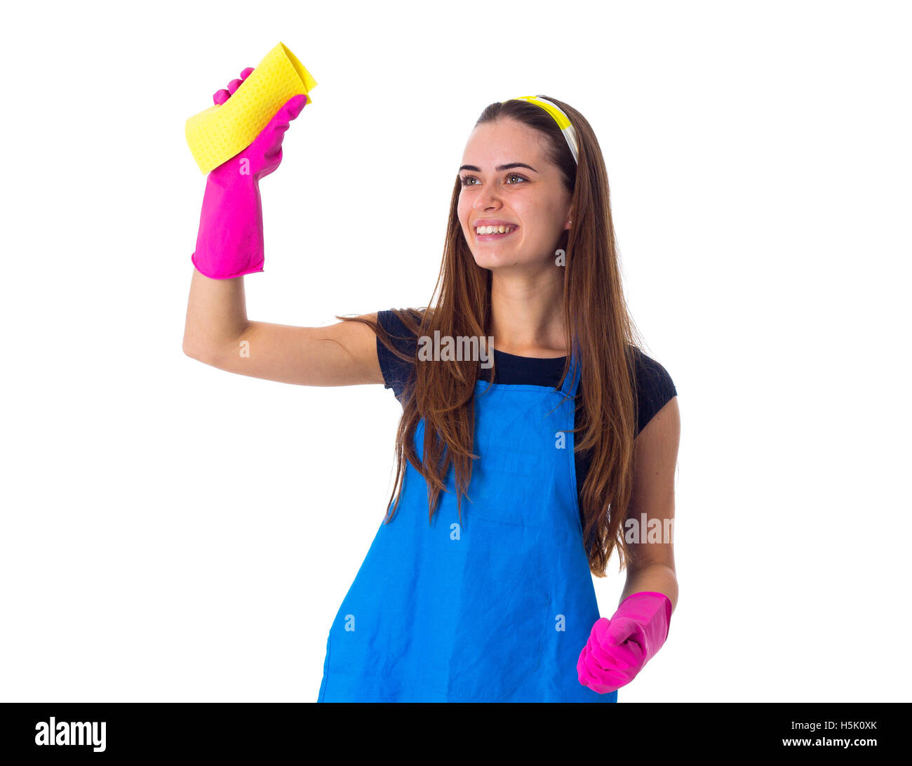 Woman in apron using a duster Stock Photo - Alamy