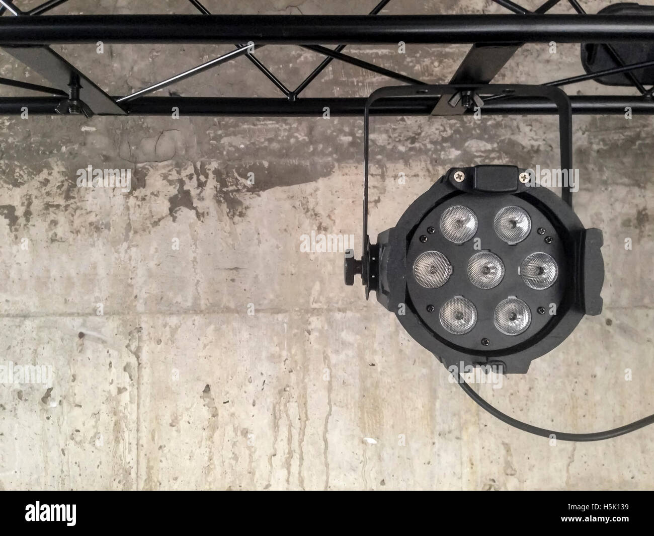 Hanging led light spot over grey dark concrete background Stock Photo ...