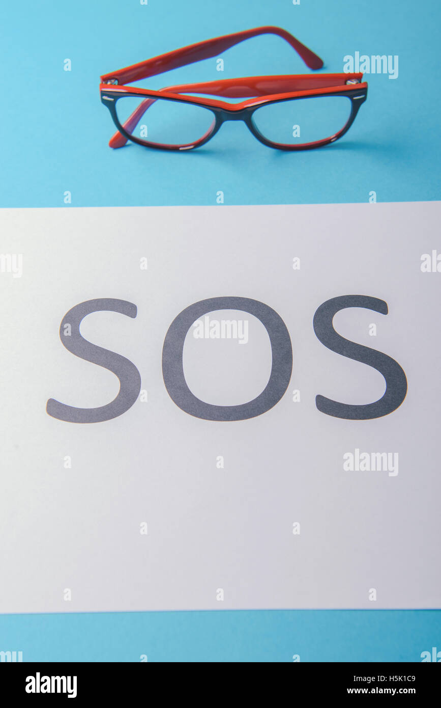 Word SOS written on white paper. Blue background Stock Photo - Alamy