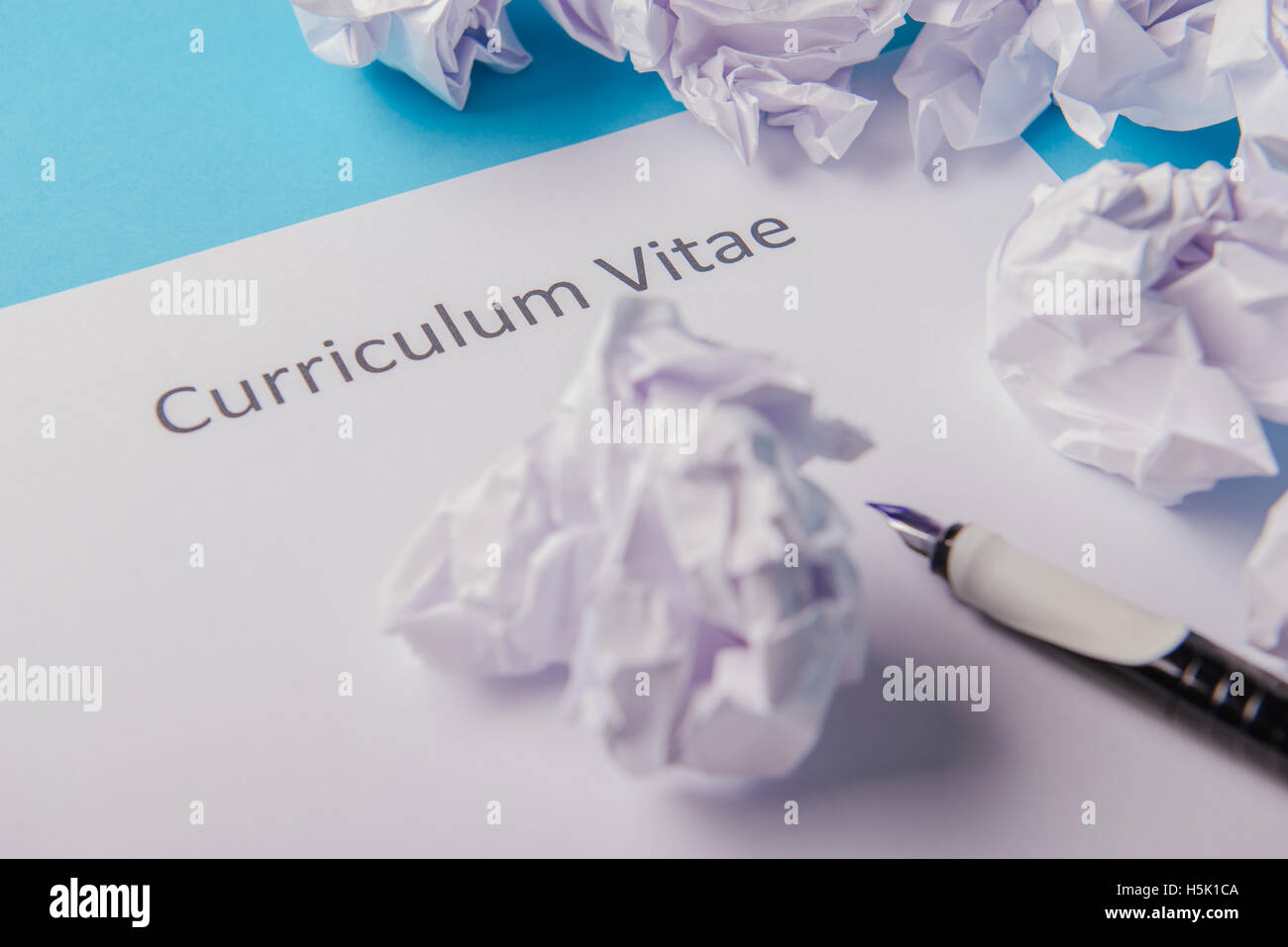 Curriculum vitae written on an blank white paper on blue background ...