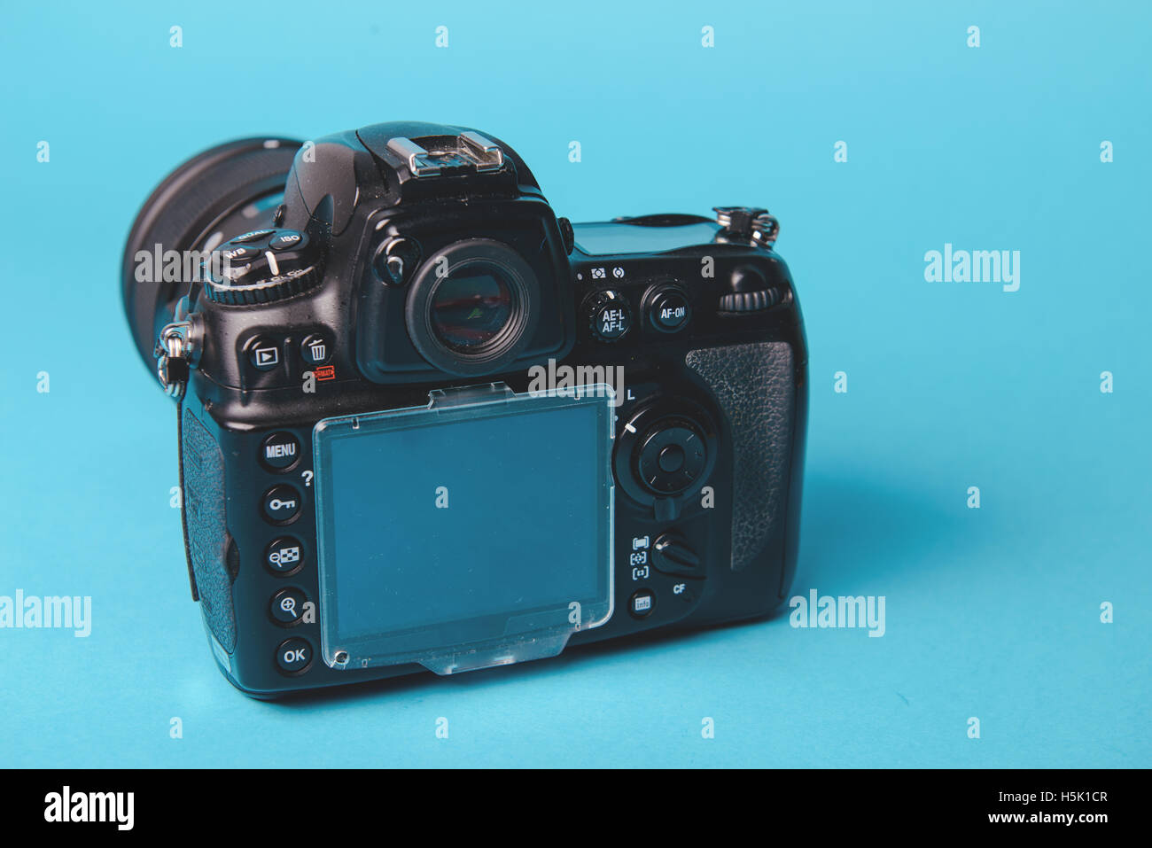 Professional modern DSLR camera against blue background Stock Photo - Alamy