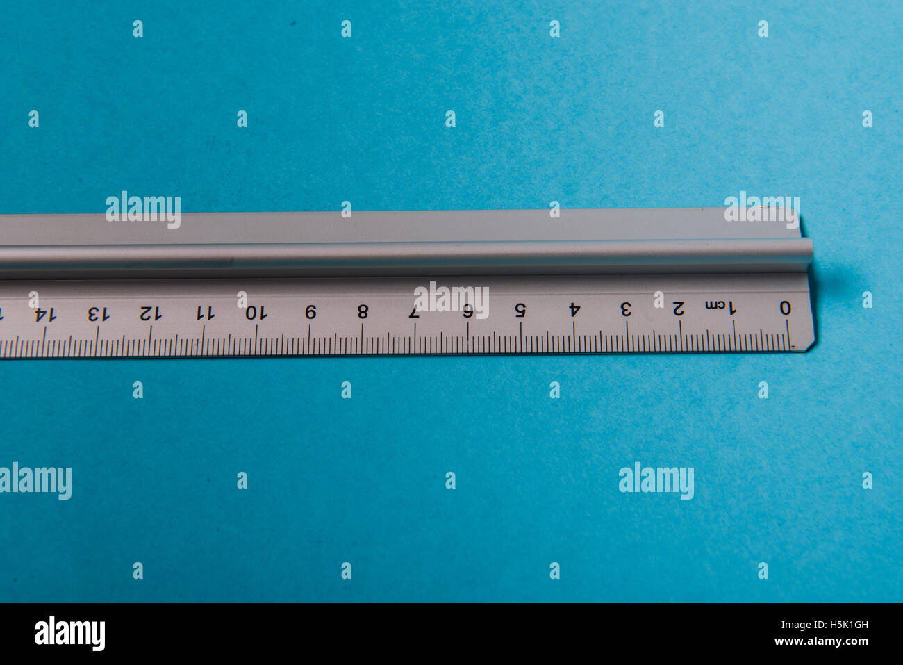 aluminum ruler on blue background. High resolution Stock Photo - Alamy
