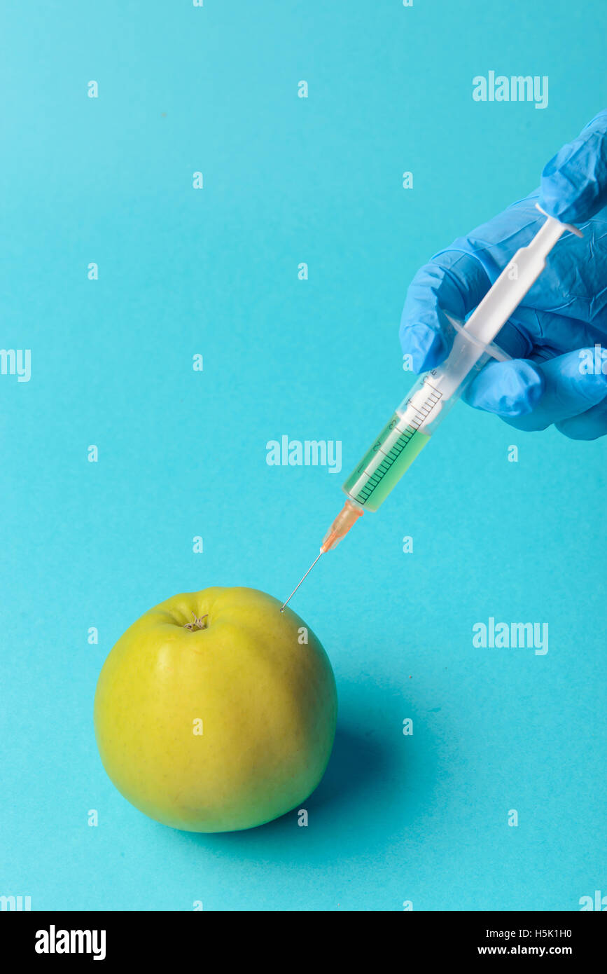 Chemical additives in food or genetically modified fruit concept. Green ...