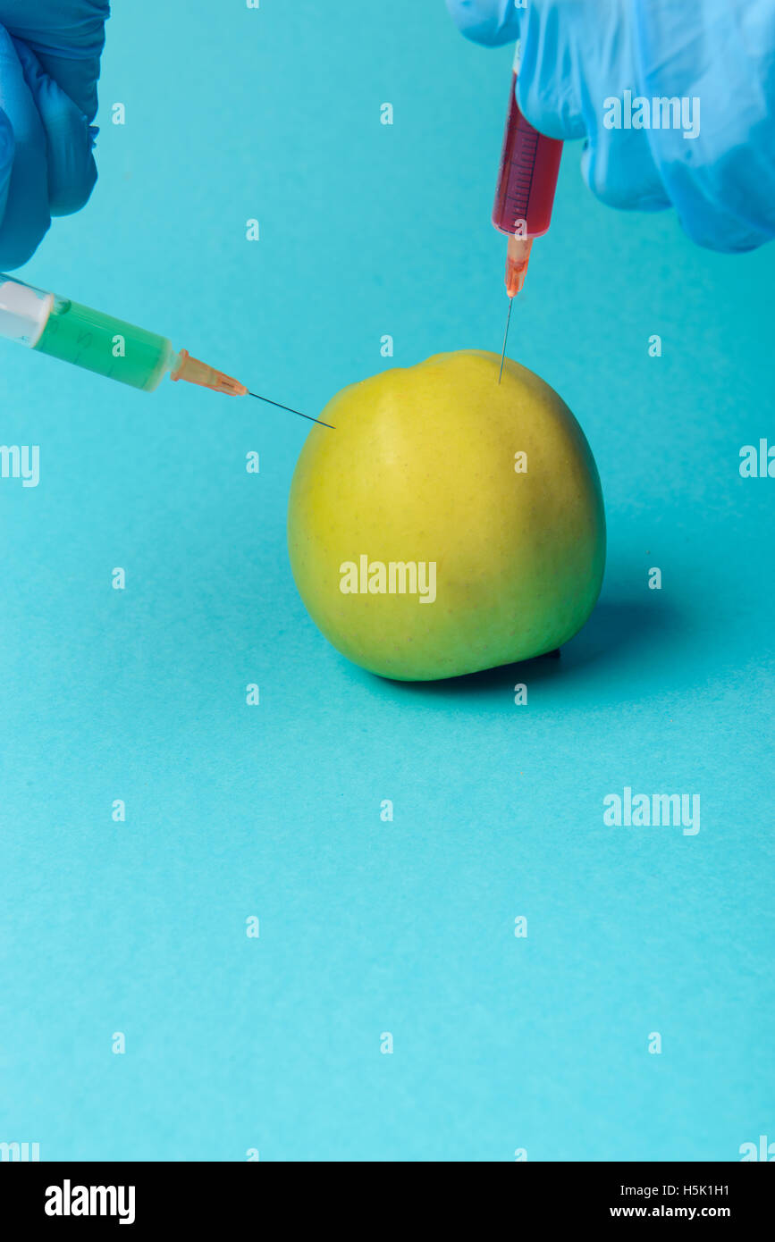 Chemical additives in food or genetically modified fruit concept. Green ...