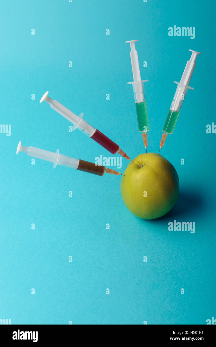 Chemical additives in food or genetically modified fruit concept. Green ...