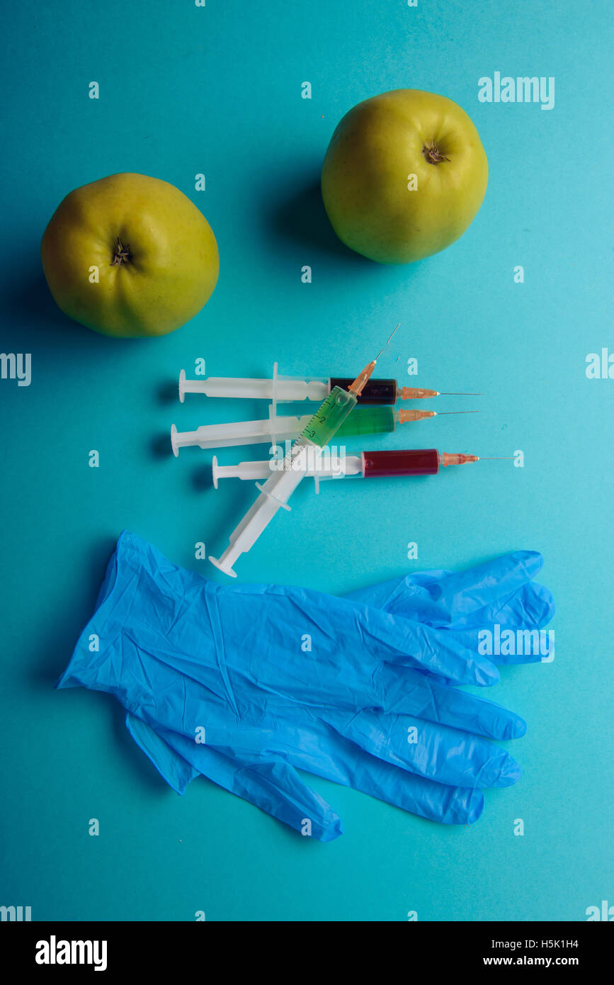 Chemical additives in food or genetically modified fruit concept. Green ...