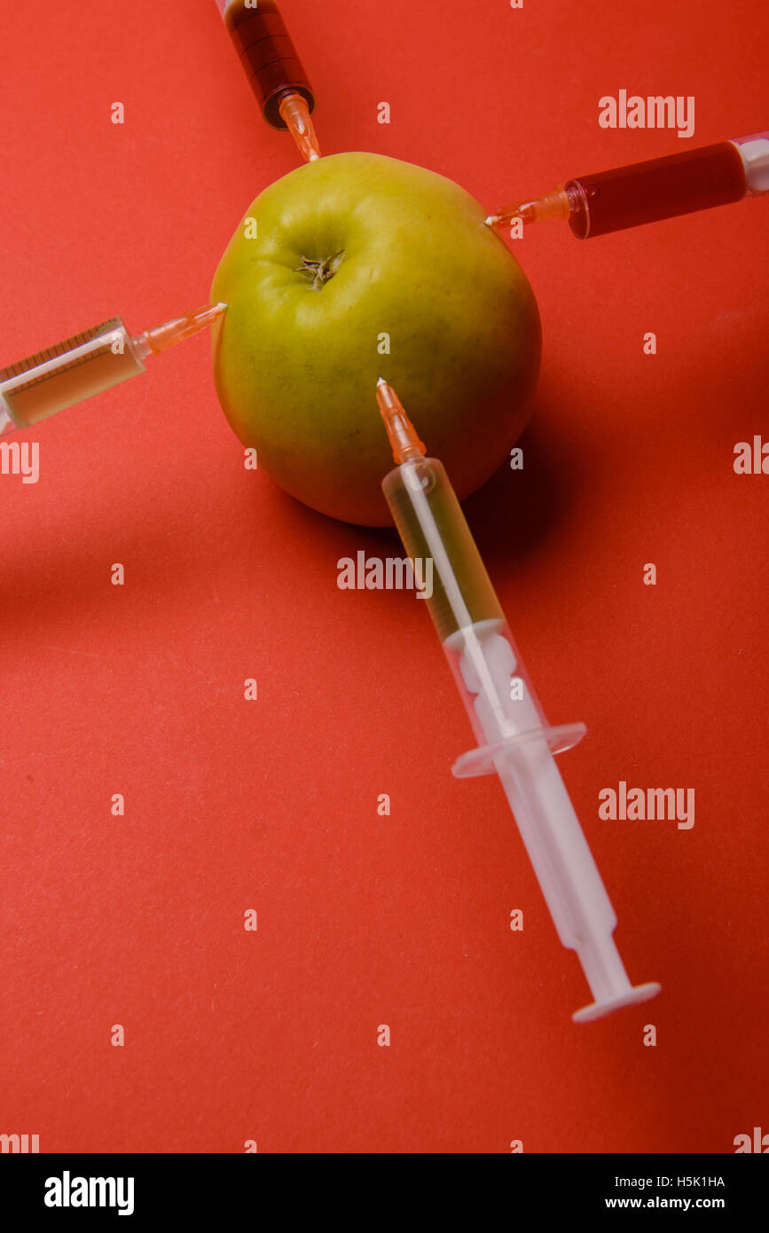 Chemical additives in food or genetically modified fruit concept. Green ...