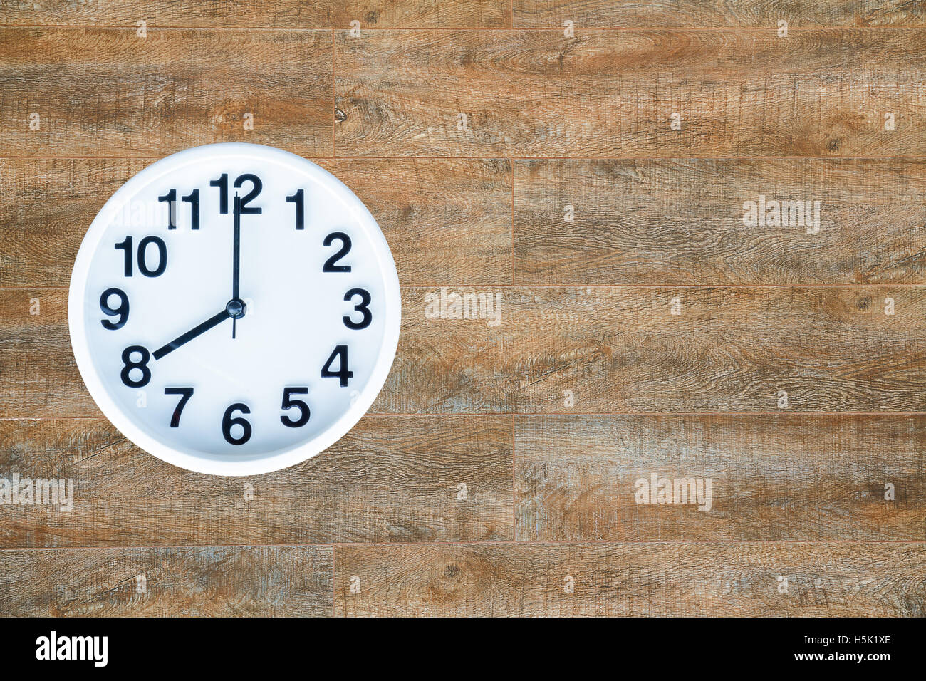 Clock show 8 am or pm on wood background with copy space. clipping path ...
