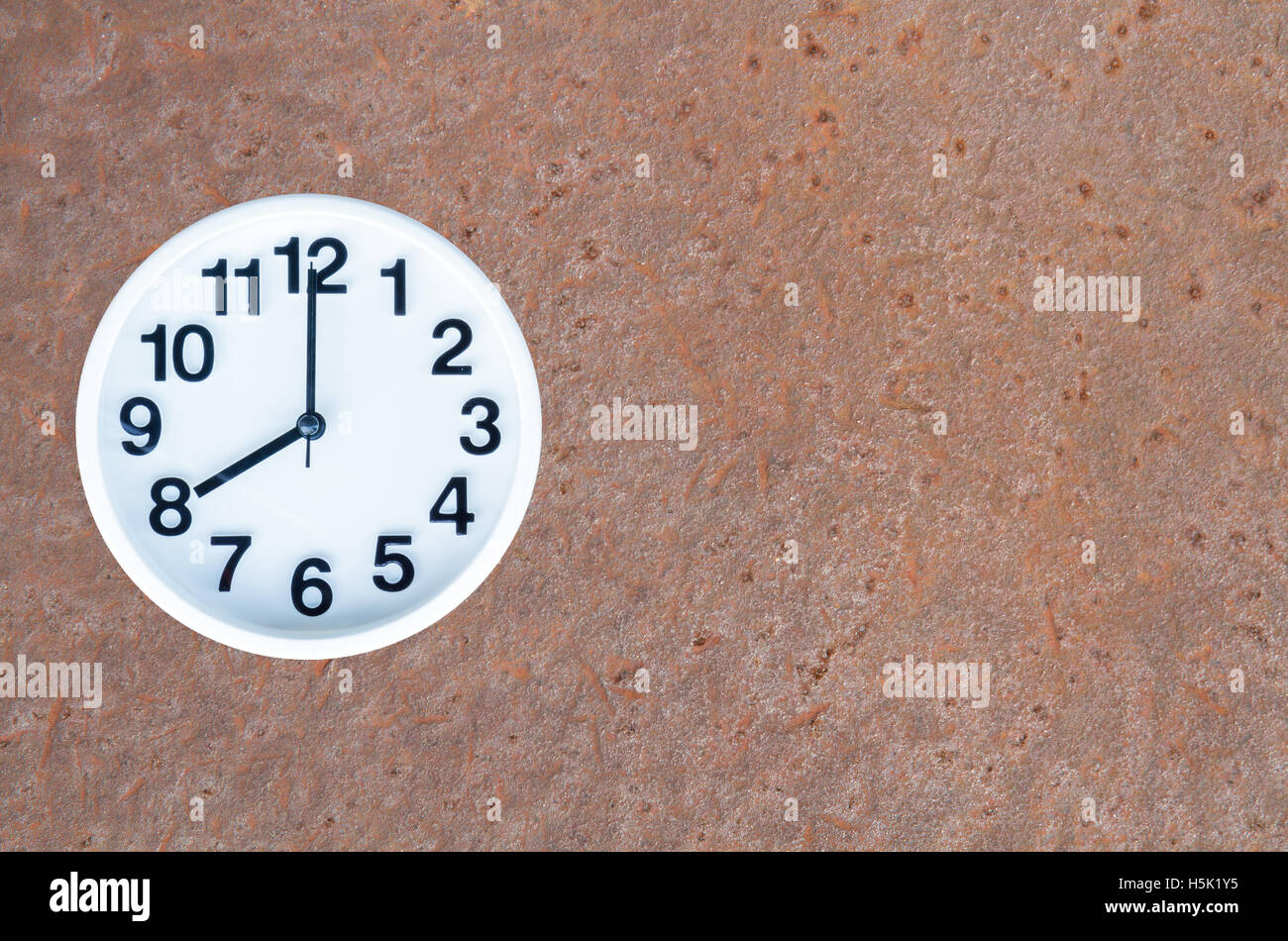 Clock show 8 am or pm on steel rusty background with copy space ...