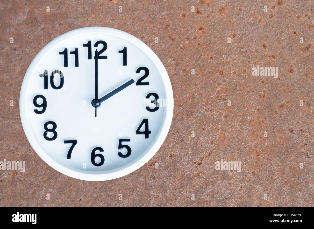 Clock show 2 am or pm on steel rusty background with copy space ...