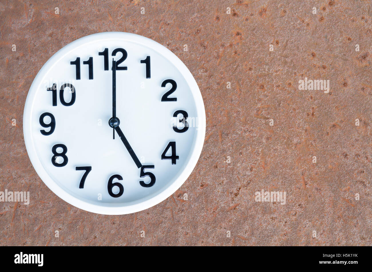 Clock show 5 am or pm on steel rusty background with copy space ...