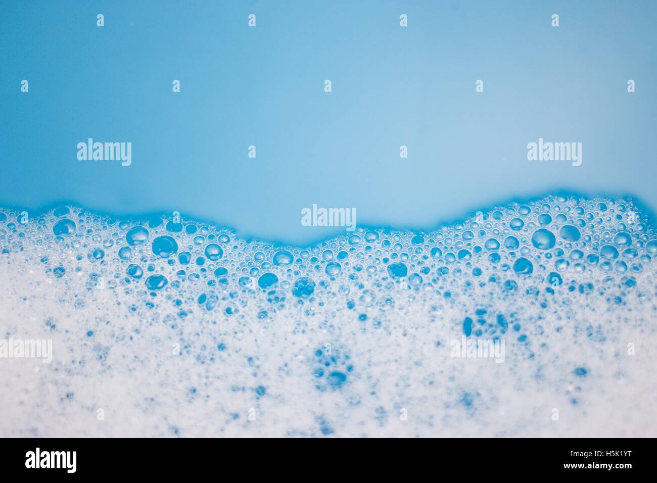 Abstract background of soap foam, suds, shower. Blue background. soft ...