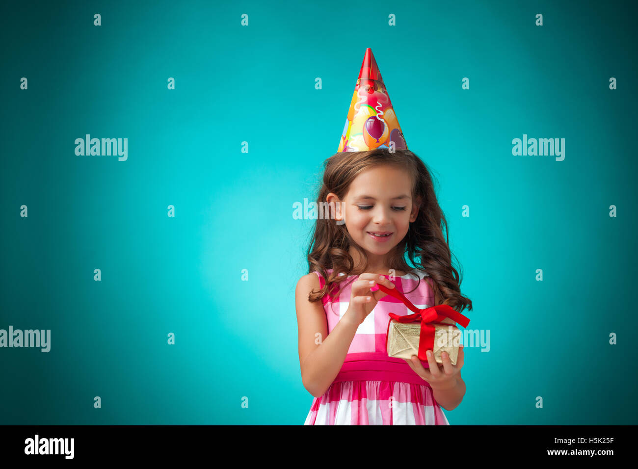 The cute cheerful little girl on blue background Stock Photo - Alamy