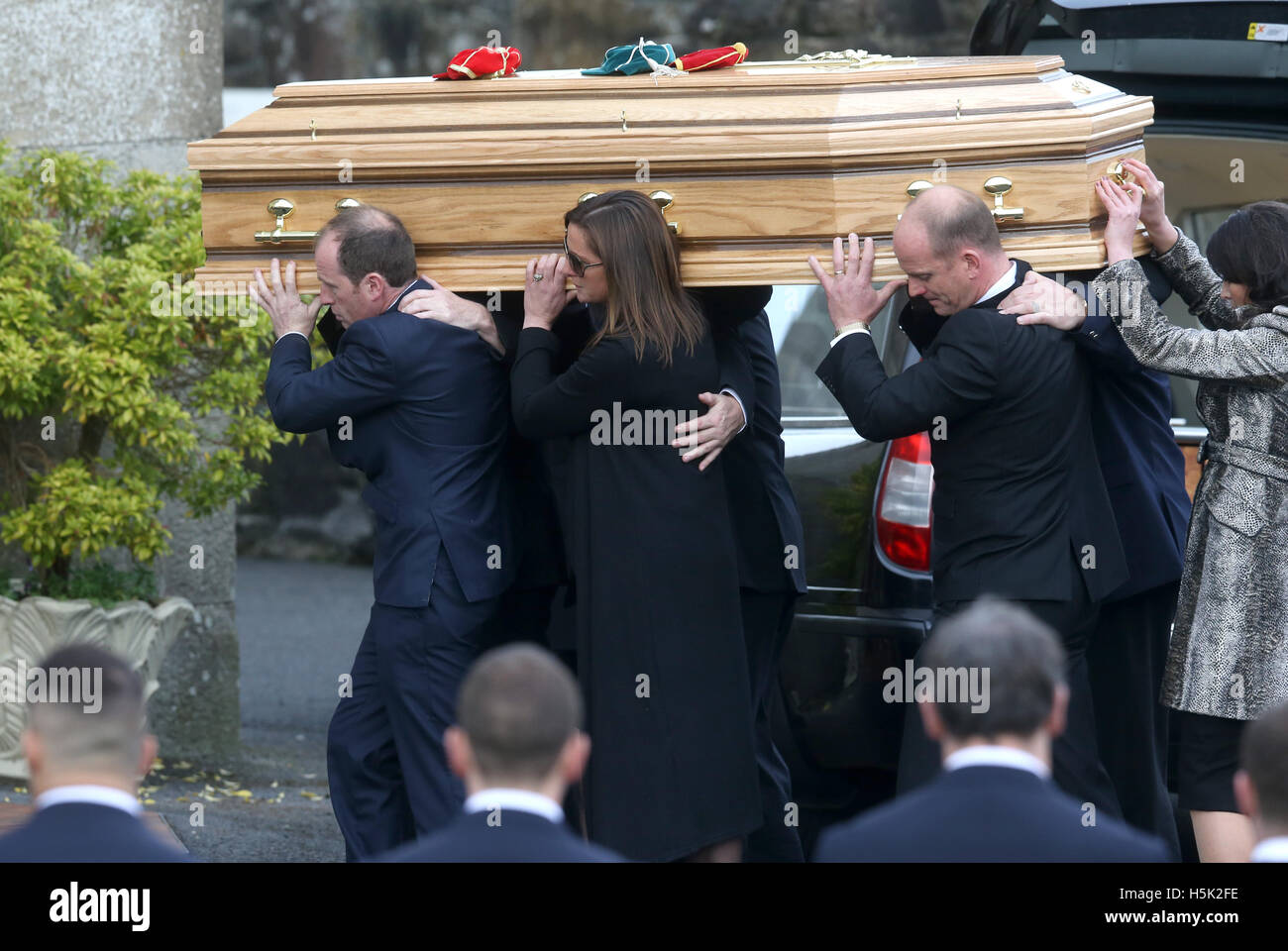 Anthony Foley's wife Olive helps carry his coffin into St Flannan's ...
