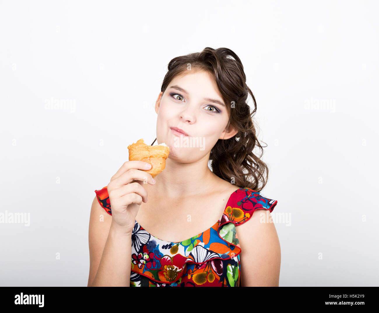 Young smile girl holding and biting bread roll Stock Photo - Alamy