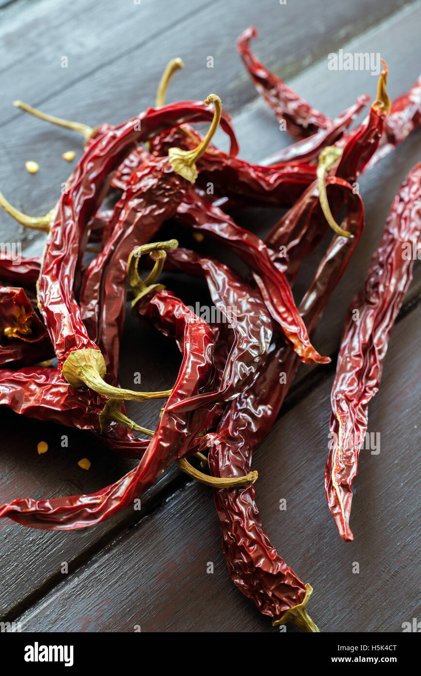 Spicy chilies on a wooden table in black Stock Photo - Alamy