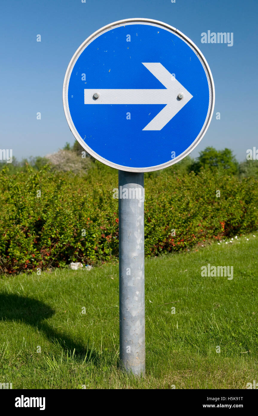 Traffic sign indicating direction of travel, sign pointing to the right ...