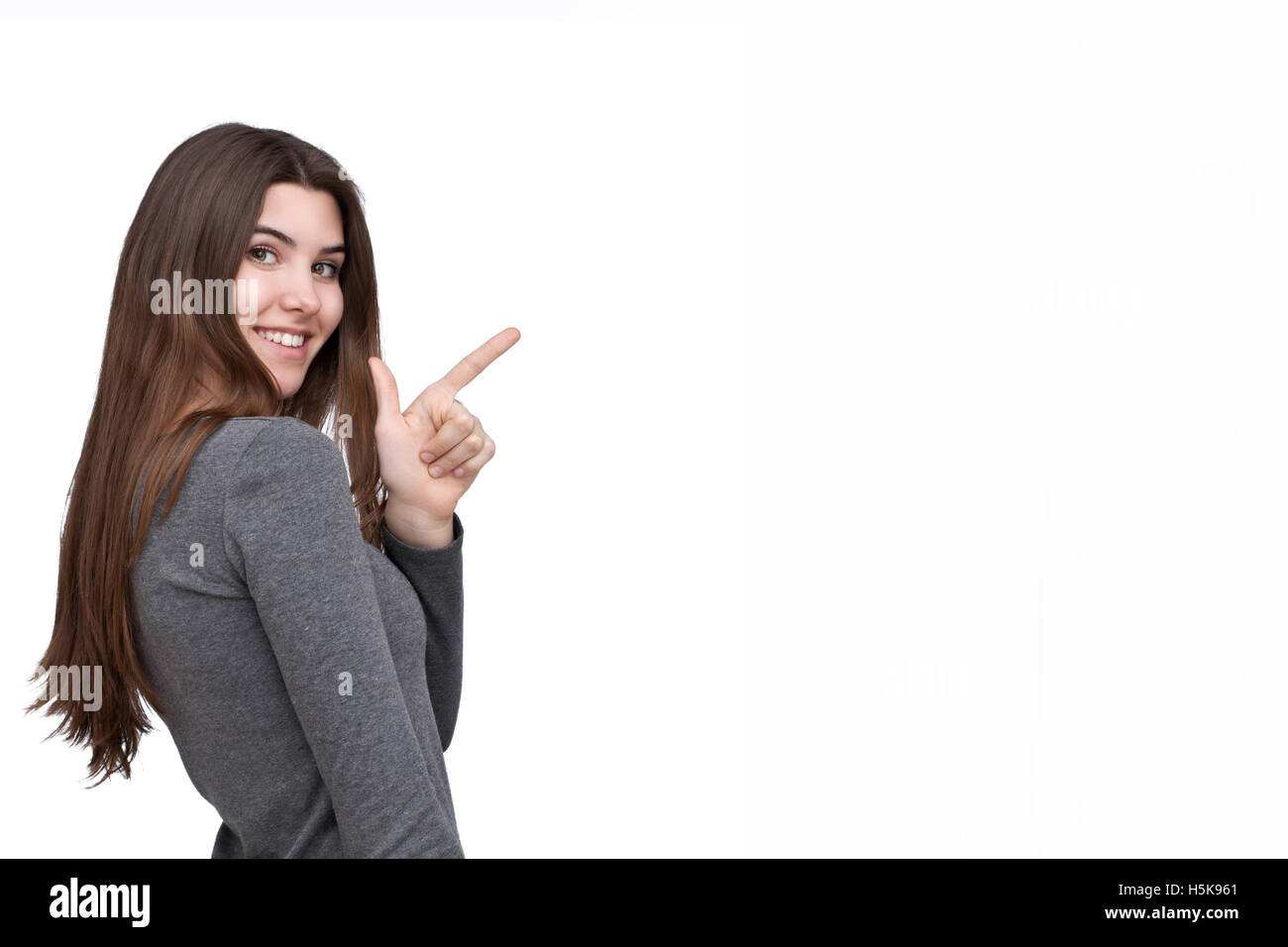 Girl pointing up on something Stock Photo - Alamy