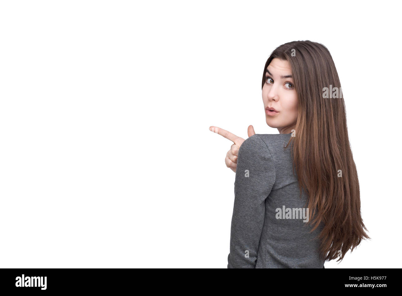 Girl pointing up on something Stock Photo - Alamy